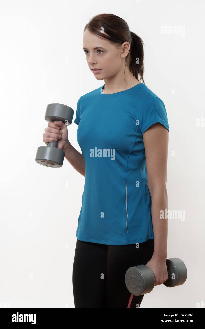 attractive woman doing a workout routine with a dumbbell weights Stock ...