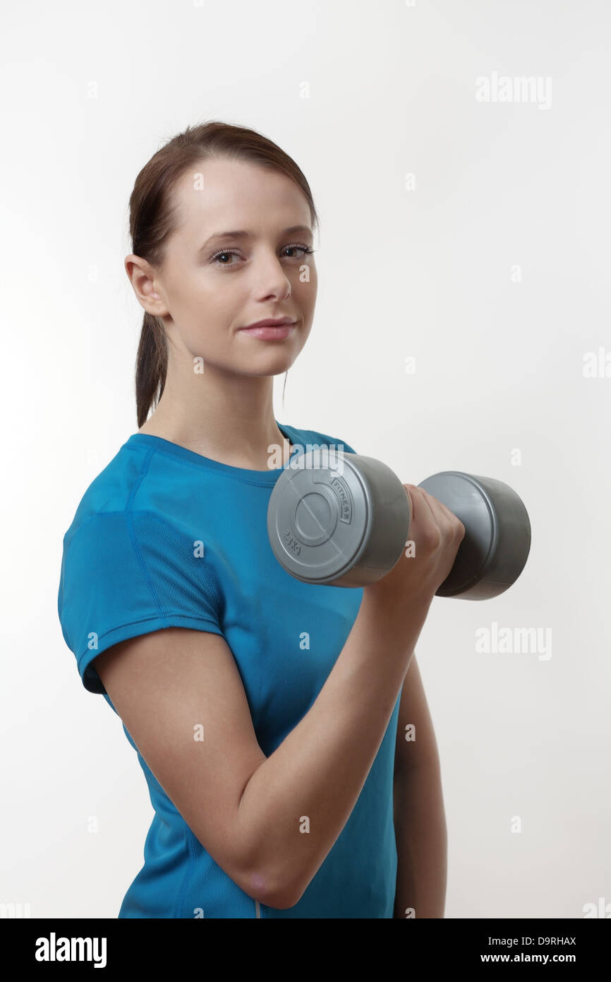 attractive woman doing a workout routine with a dumbbell weights Stock ...