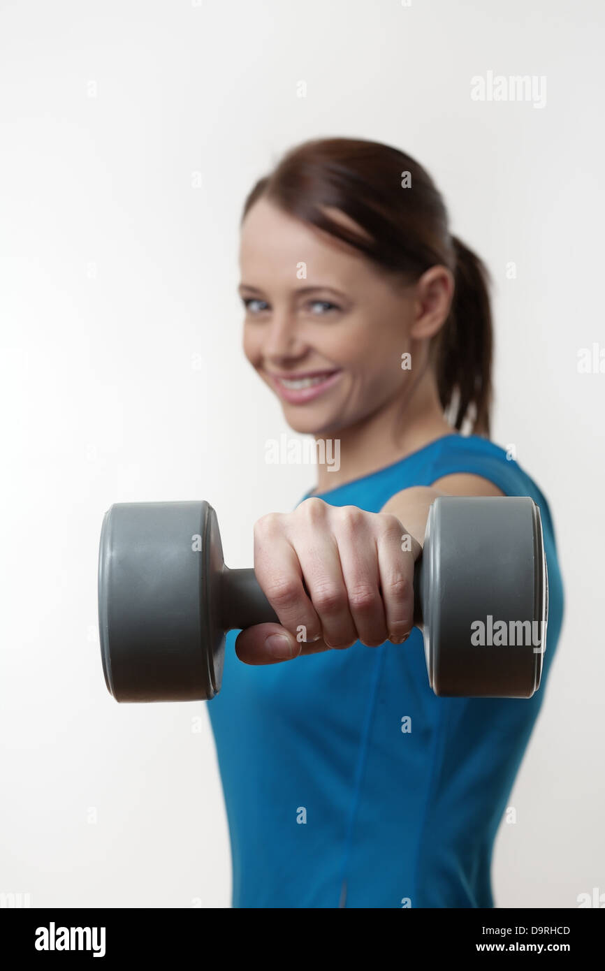 attractive woman doing a workout routine with a dumbbell weights Stock ...