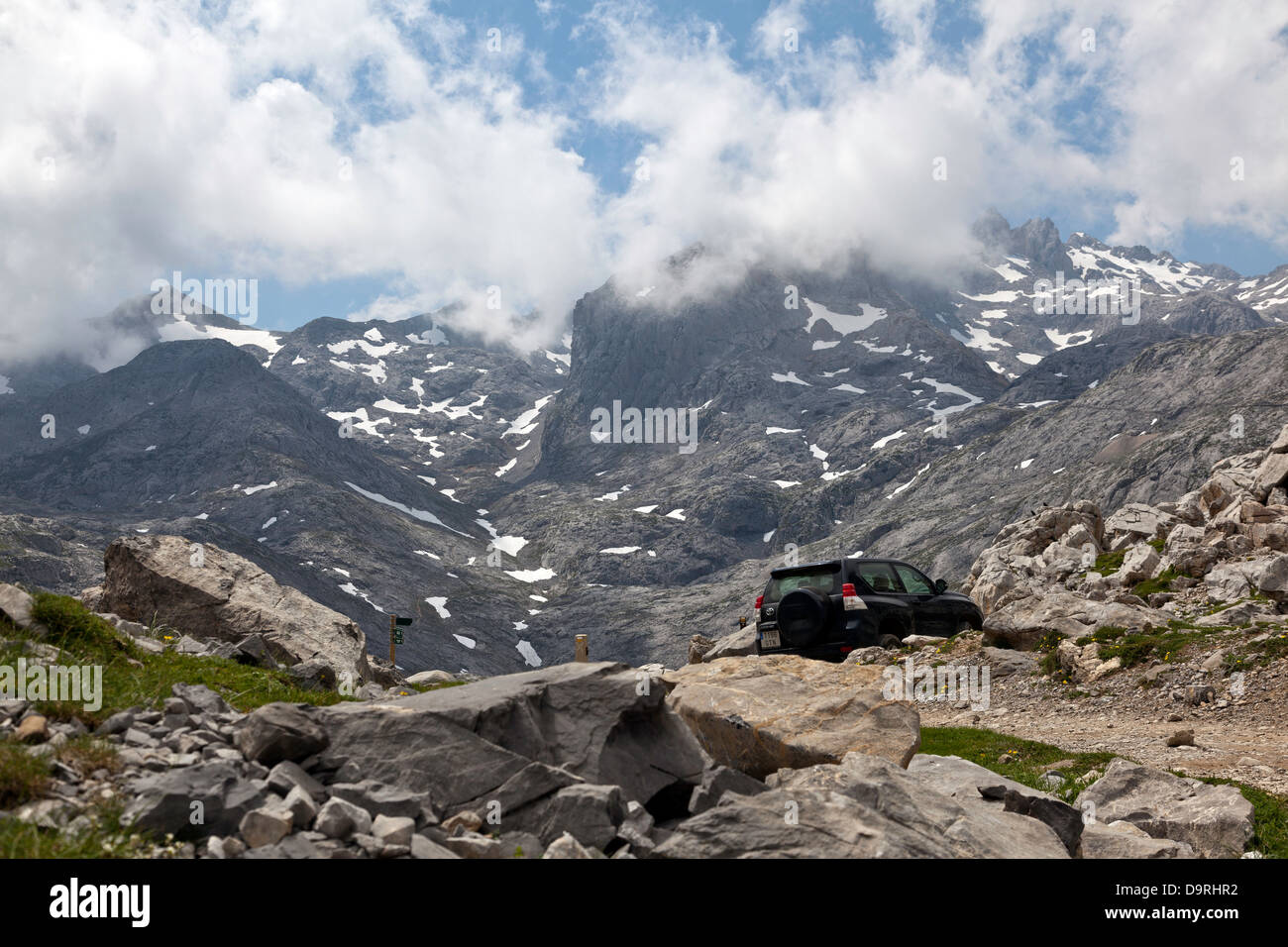 Off-road 4x4 car parked on a hiking trail in the Picos de Europe above ...