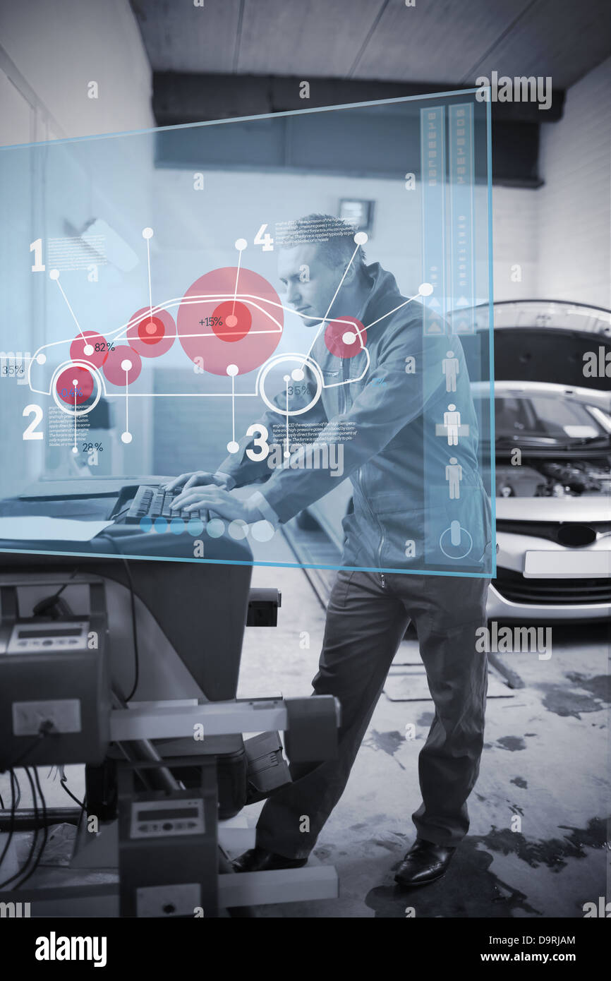 Mechanic typing while consulting futuristic interface Stock Photo - Alamy