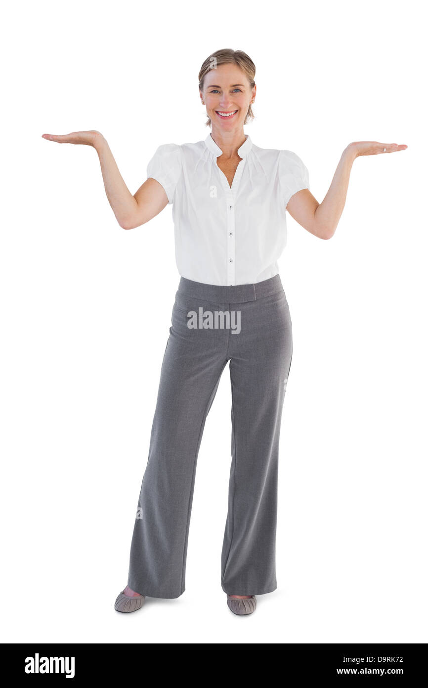 Smiling businesswoman presenting something with her two hands raised ...