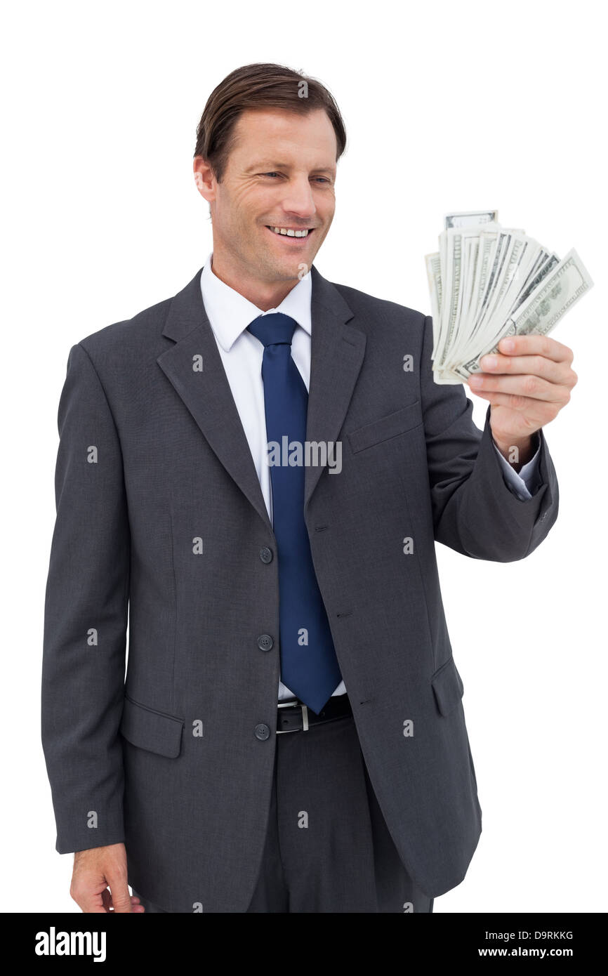 Smiling businessman holding bills Stock Photo - Alamy