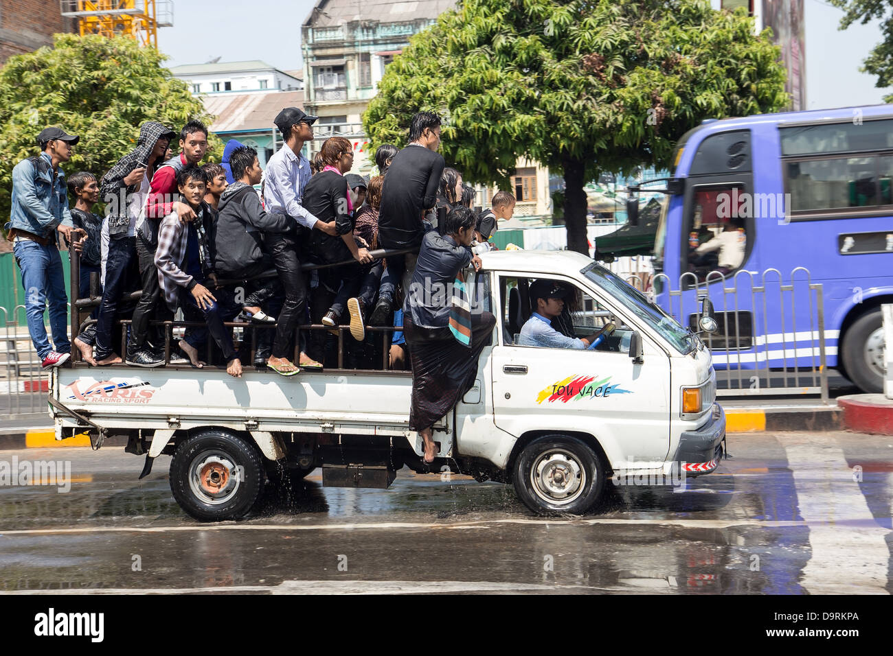 people riding on a car in the streets of Yangon Stock Photo - Alamy
