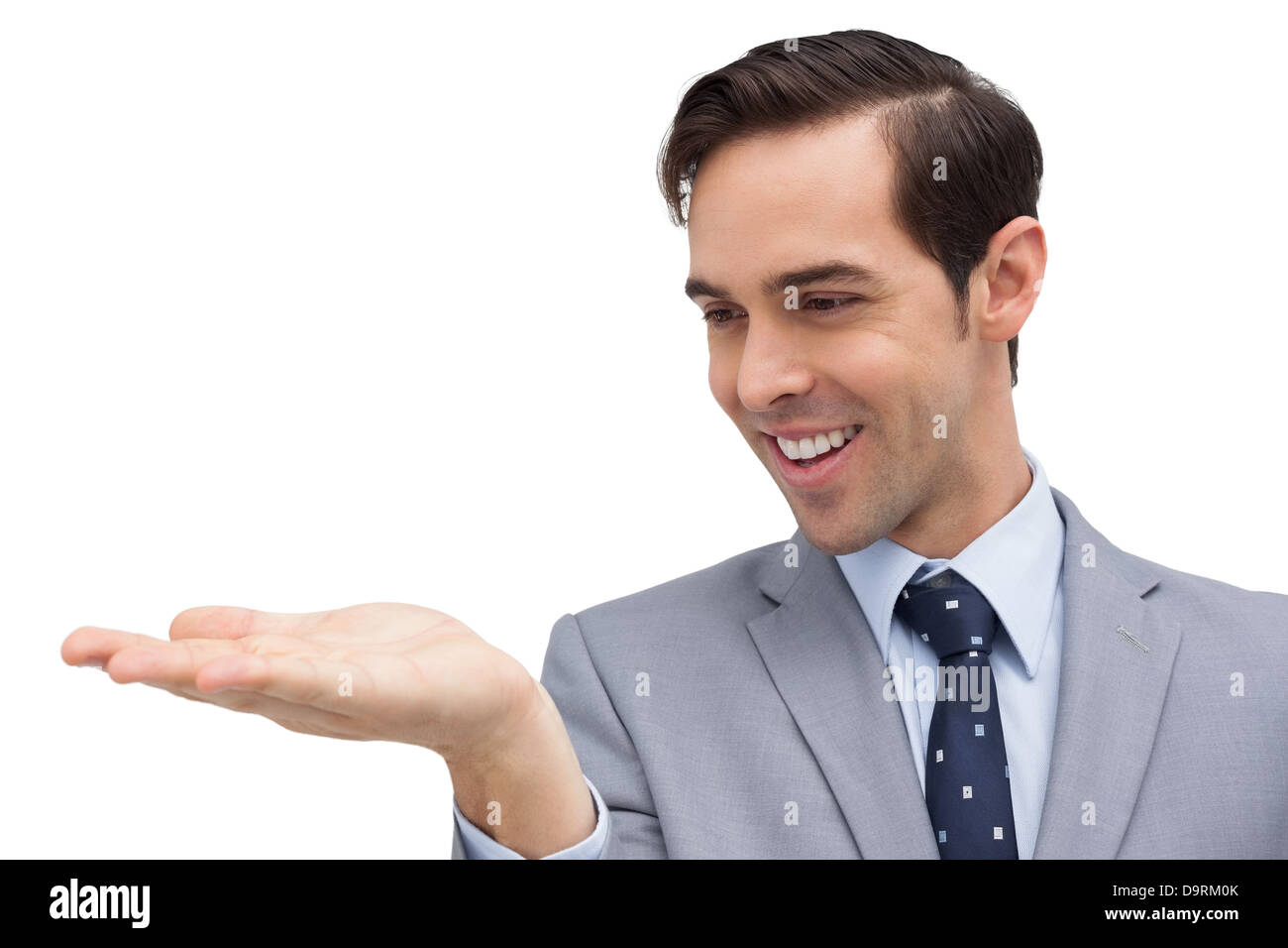 Businessman looking at and showing his opened hand Stock Photo - Alamy