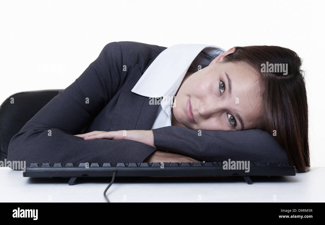 young looking woman almost asleep at her desk at work Stock Photo - Alamy