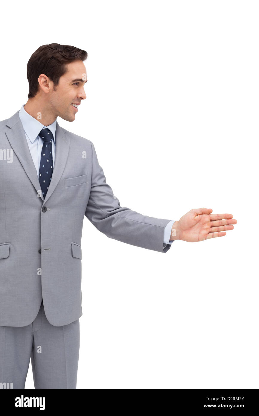 Young businessman giving his hand Stock Photo - Alamy