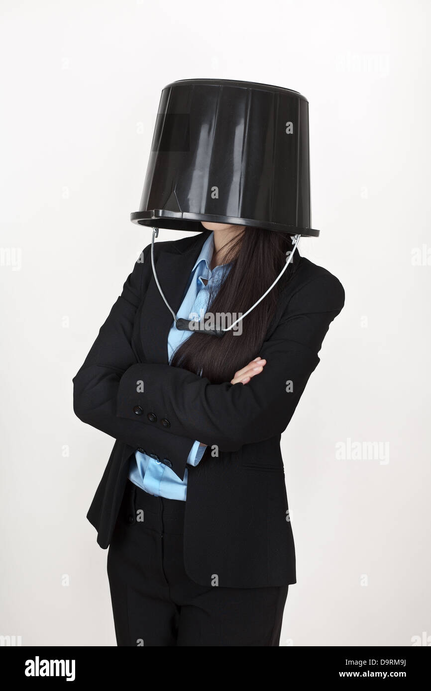 business woman in a suit with a bucket on her head Stock Photo - Alamy