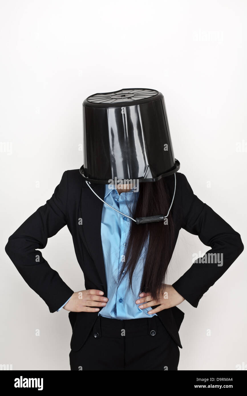 business woman in a suit with a bucket on her head Stock Photo - Alamy