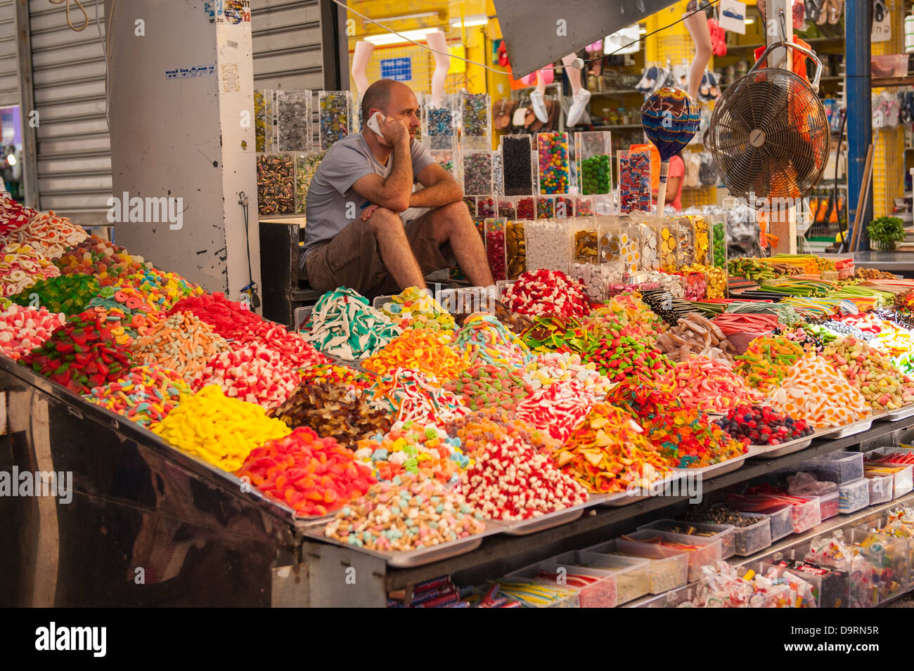 Israel Tel Aviv Carmel Market vendor seller man mobile cell phone ...