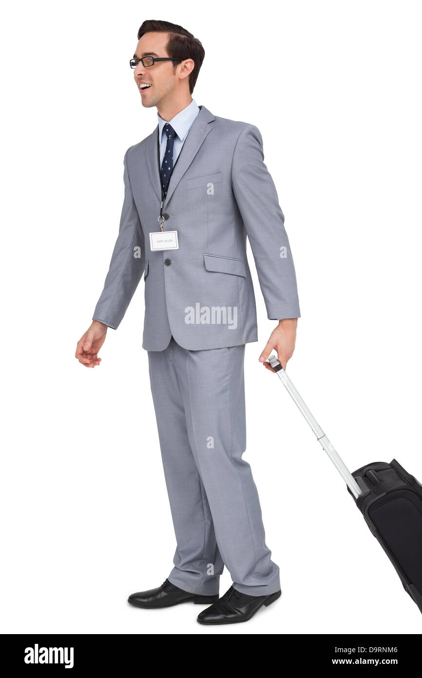 Smiling businessman walking with his suitcase Stock Photo - Alamy