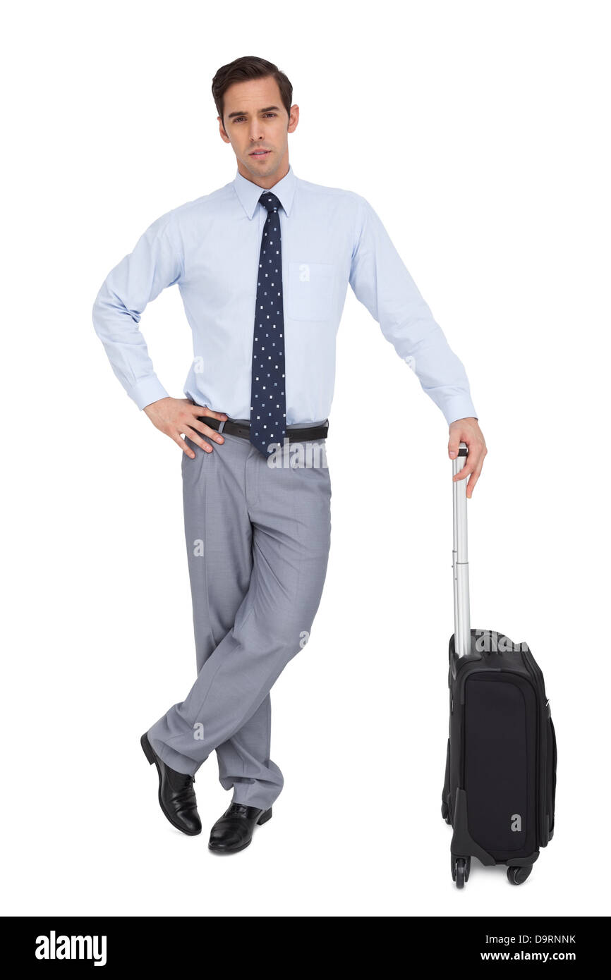 Handsome businessman standing with his suitcase Stock Photo - Alamy