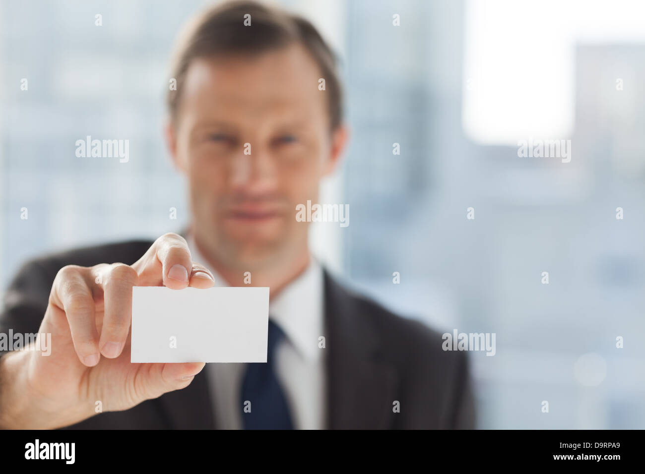 Businessman showing business card Stock Photo - Alamy