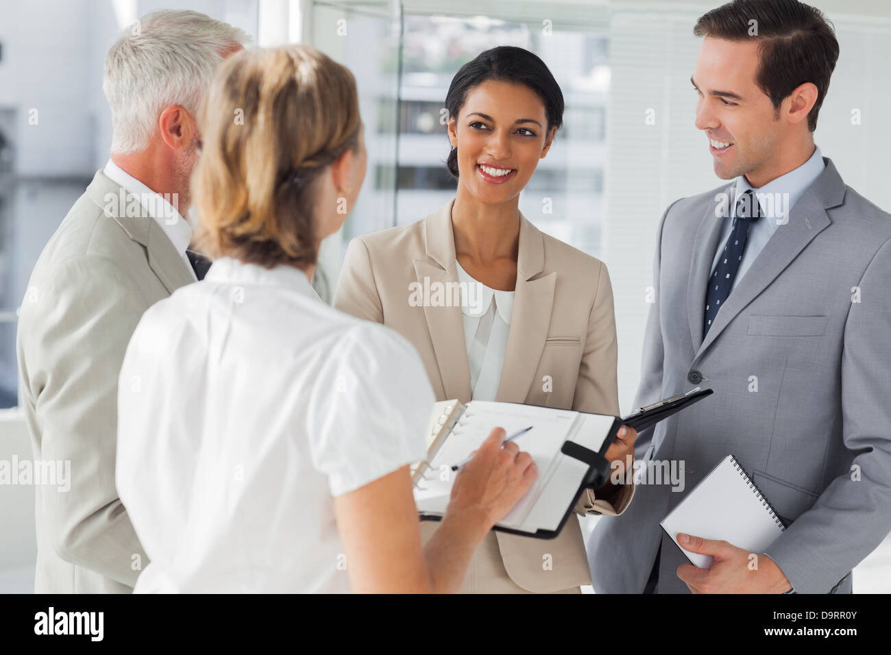 Cheerful business people making an appointment Stock Photo - Alamy