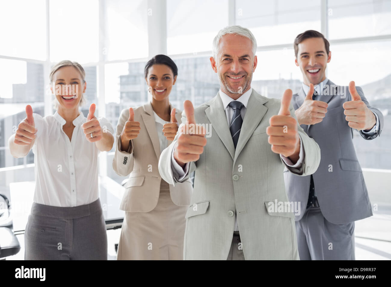 Business people giving thumbs up Stock Photo - Alamy