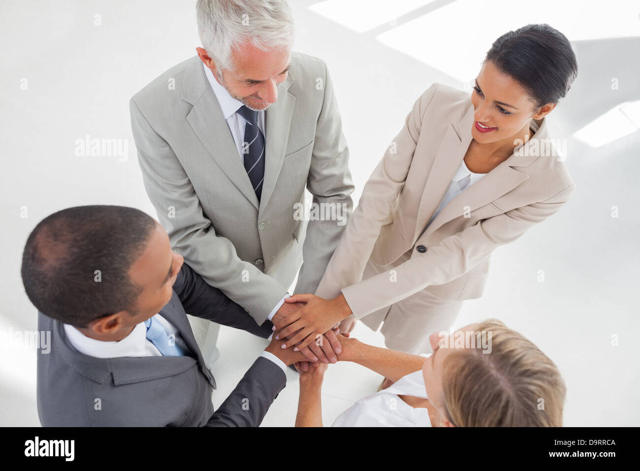 United team standing together and piling up their hands Stock Photo - Alamy