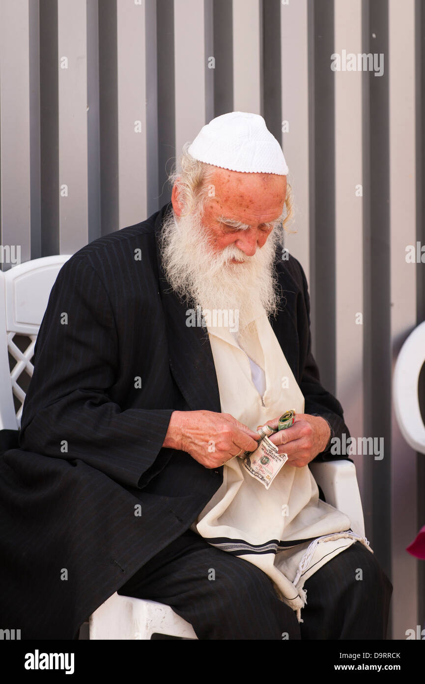 Israel Jerusalem Old City white bearded Orthodox Jew sitting counting ...