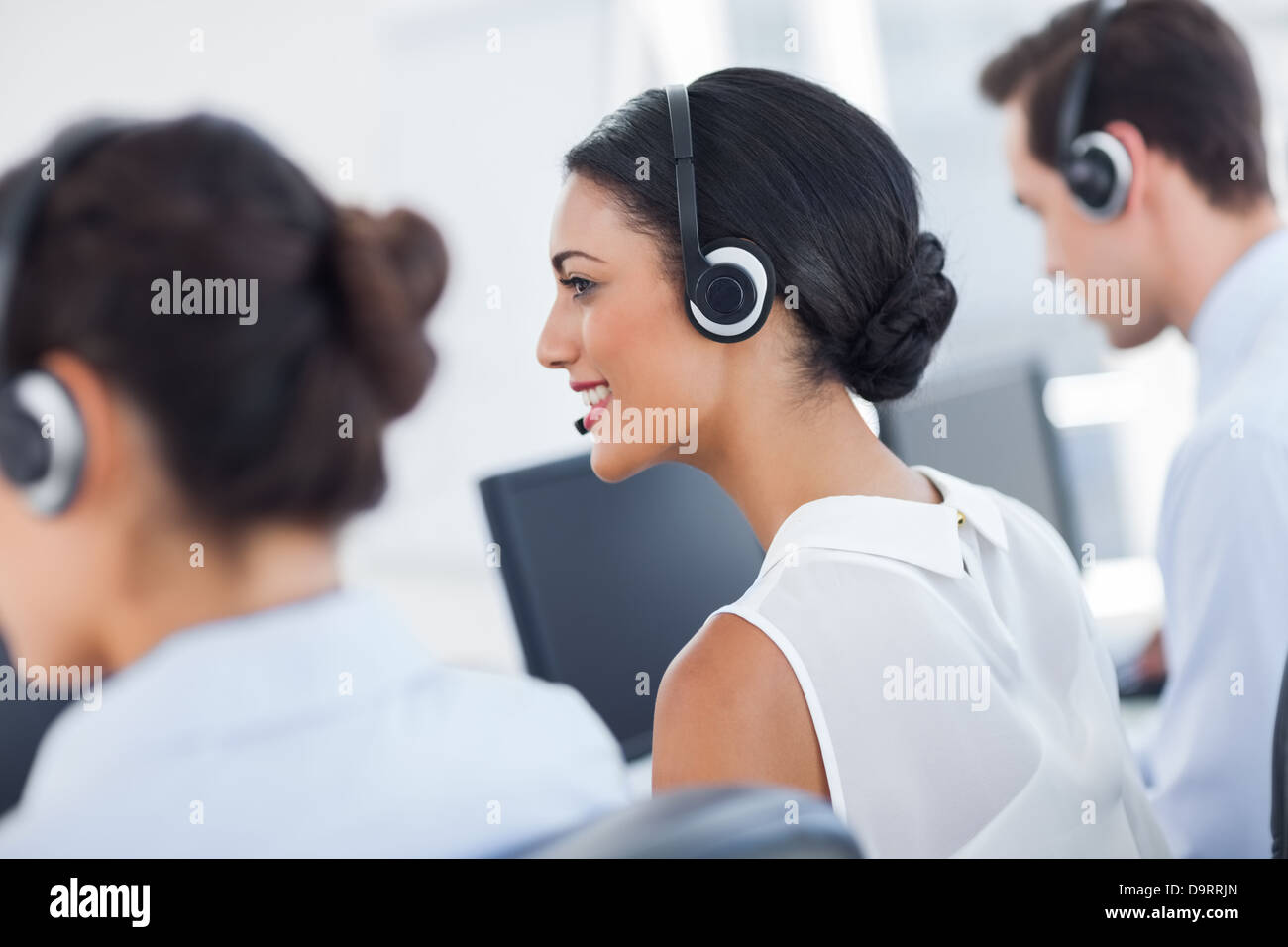 Three call centre employees working Stock Photo - Alamy