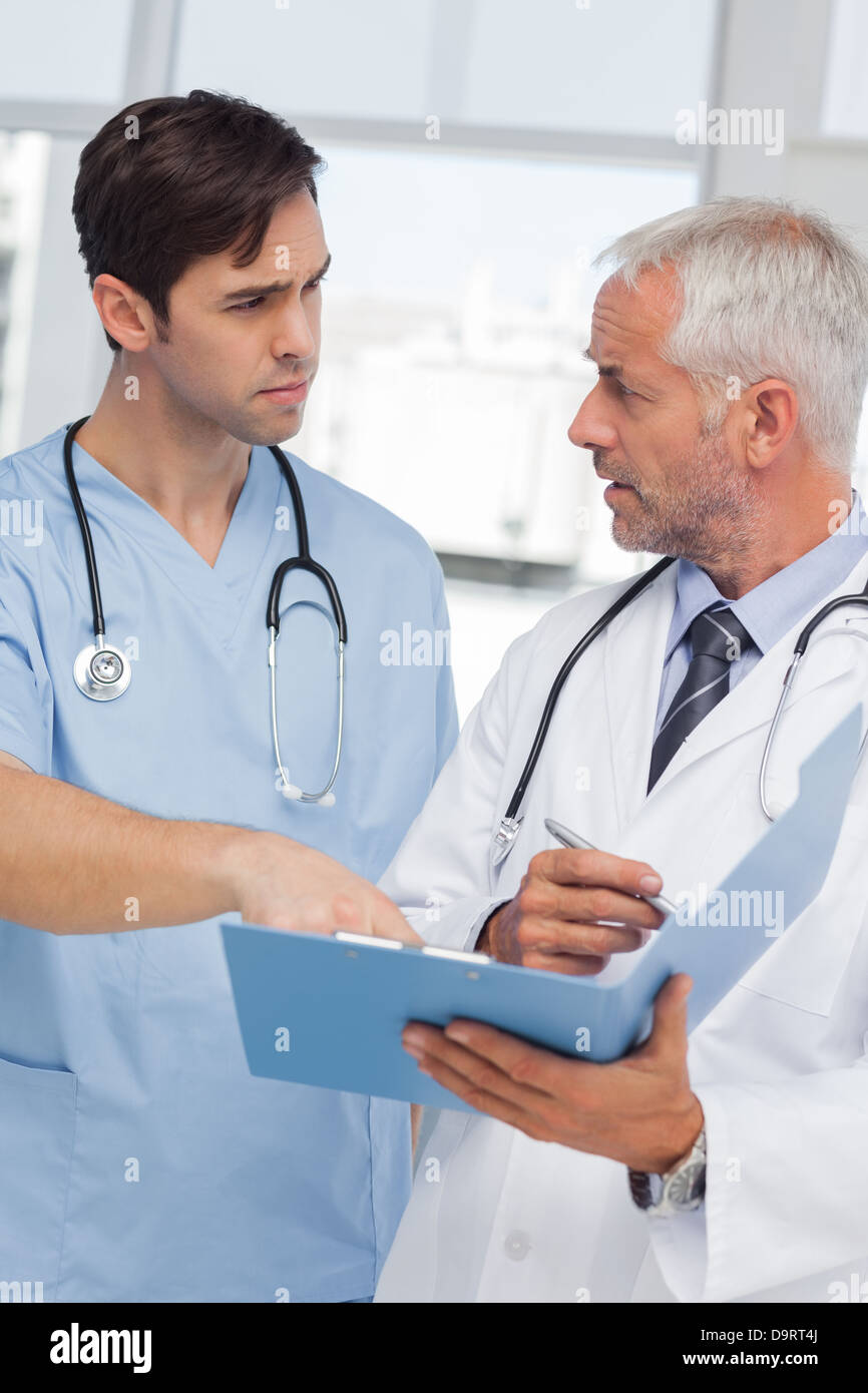 Serious doctors talking about file Stock Photo - Alamy