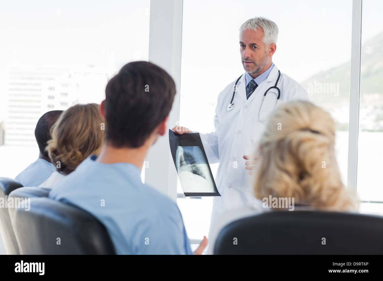 Doctor presenting x-ray Stock Photo - Alamy