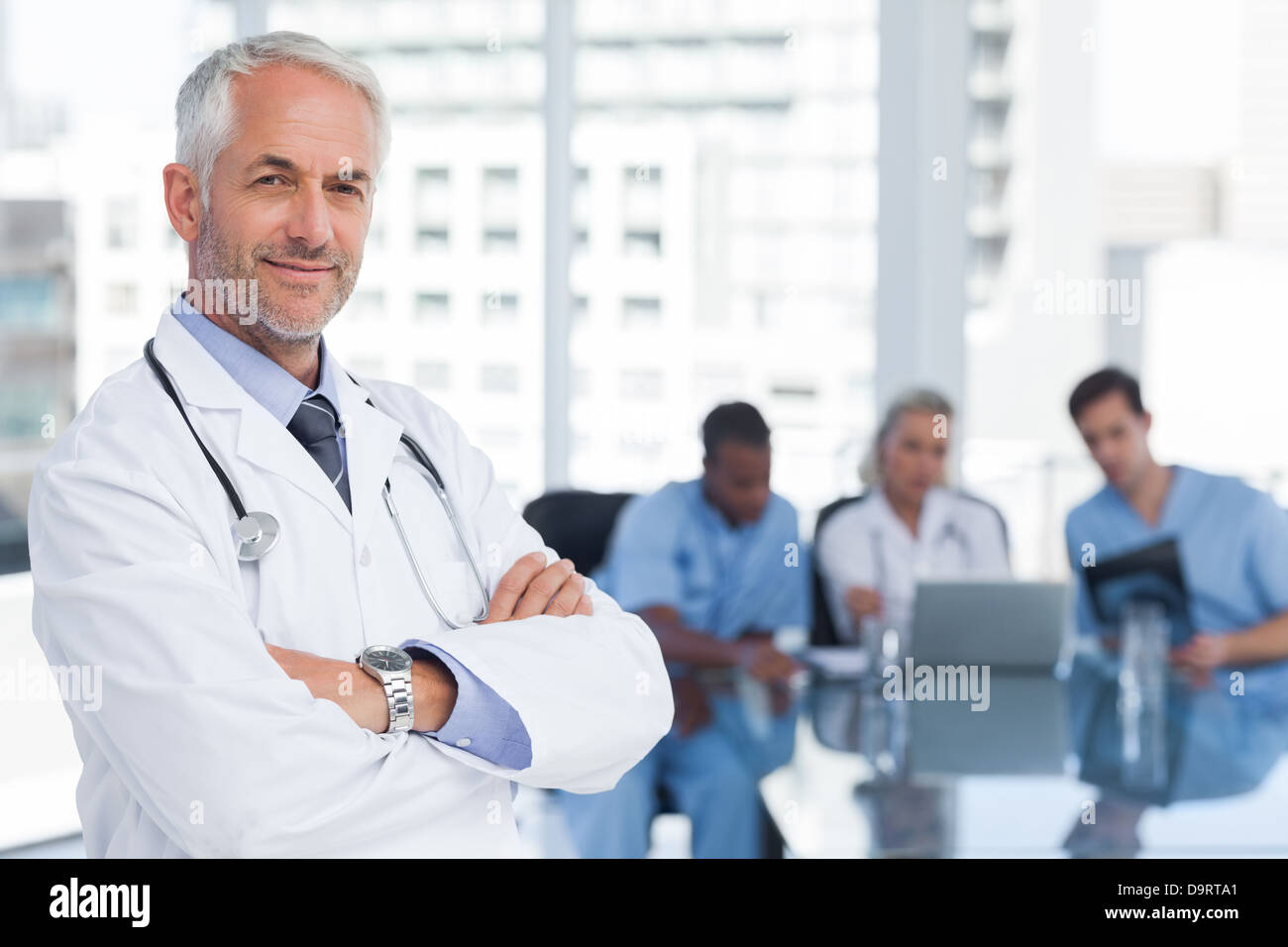 Doctor with arms folded Stock Photo - Alamy