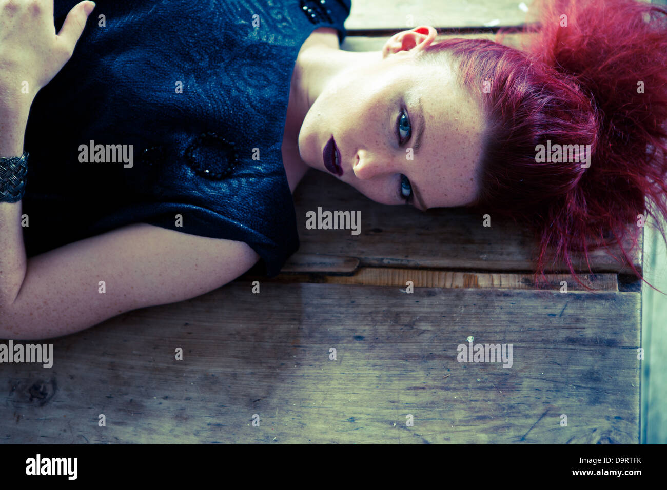 Red headed girl on a table Stock Photo - Alamy