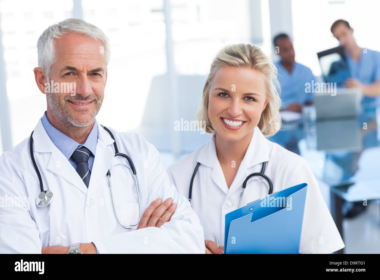 Doctors holding blue file Stock Photo - Alamy