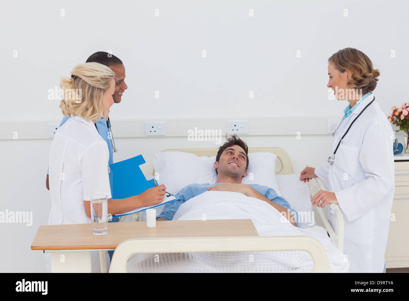 Medical team taking care of a sick patient Stock Photo - Alamy