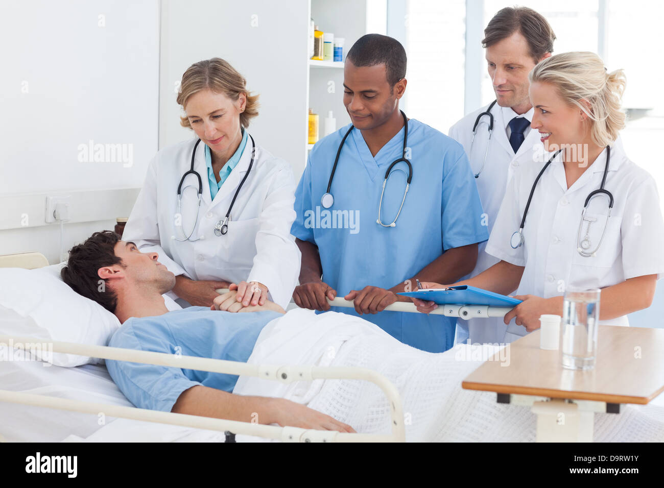 Medical team talking to a patient Stock Photo - Alamy