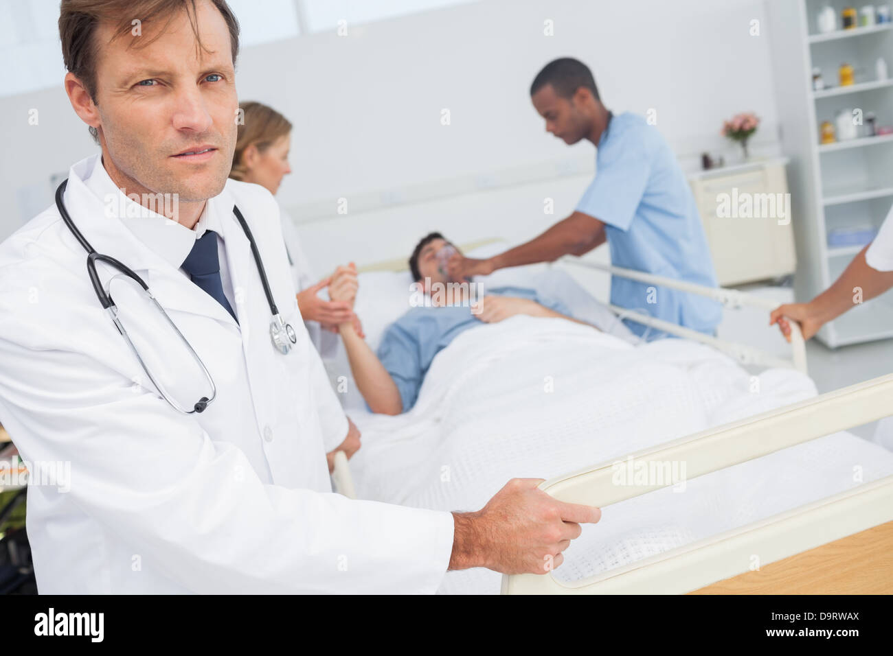 Serious doctor looking at the camera Stock Photo - Alamy