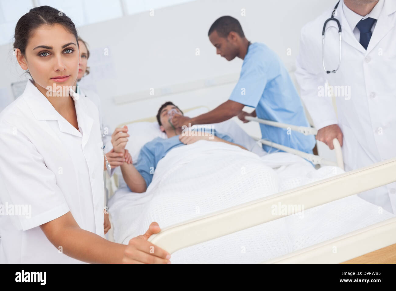 Nurse pushing bed of patient in emergency Stock Photo - Alamy