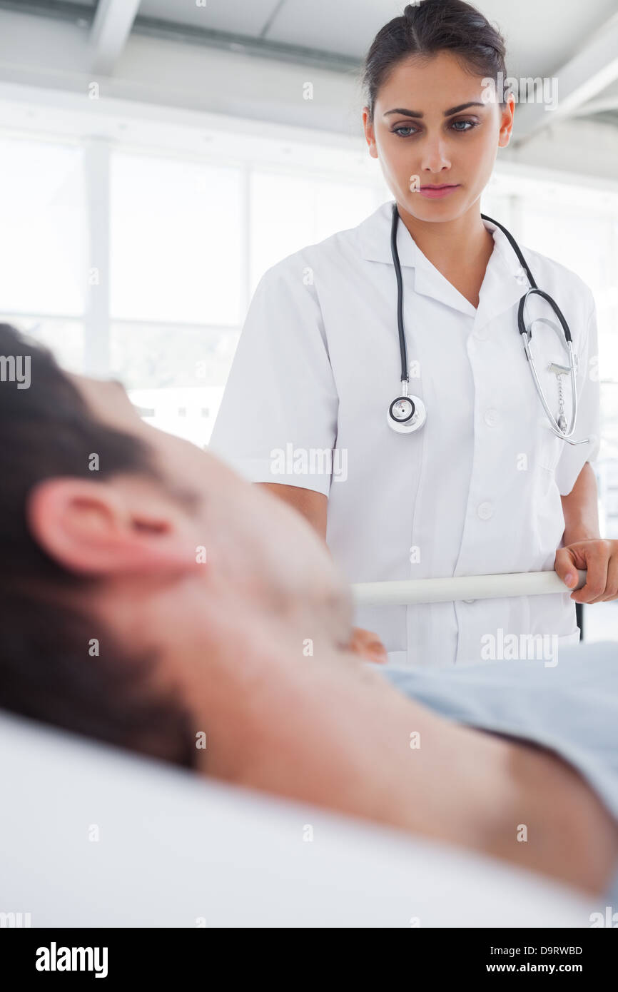 Serious nurse taking care of a patient Stock Photo - Alamy