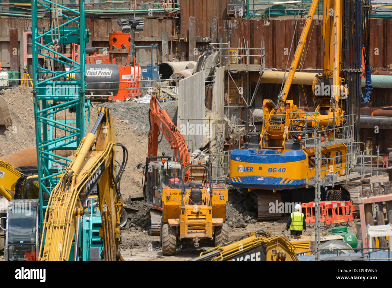 Congested construction site with machines carrying out foundation work ...