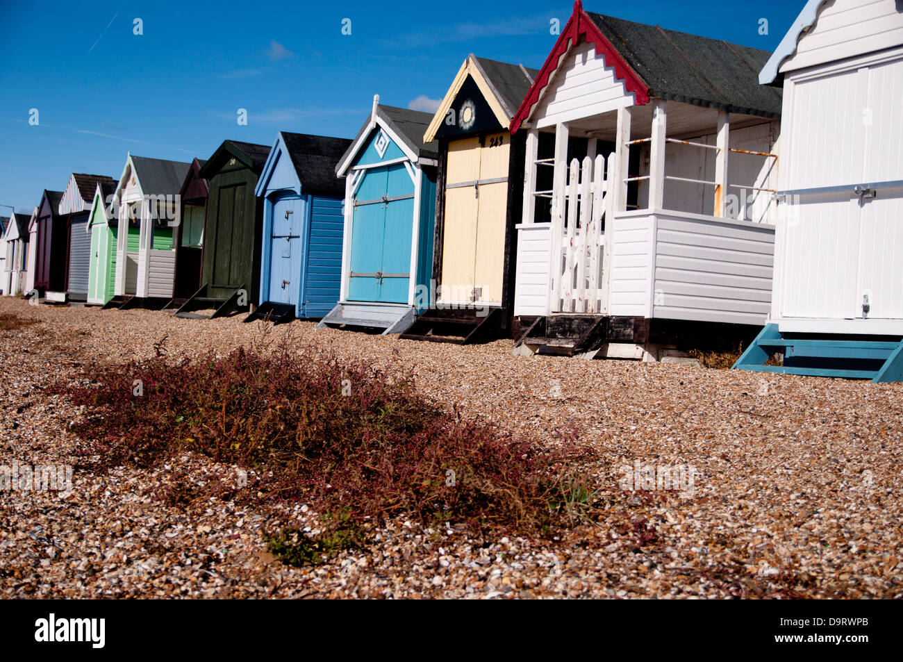 Seafront views showing beach huts , sand, sea and blue sky Stock Photo ...