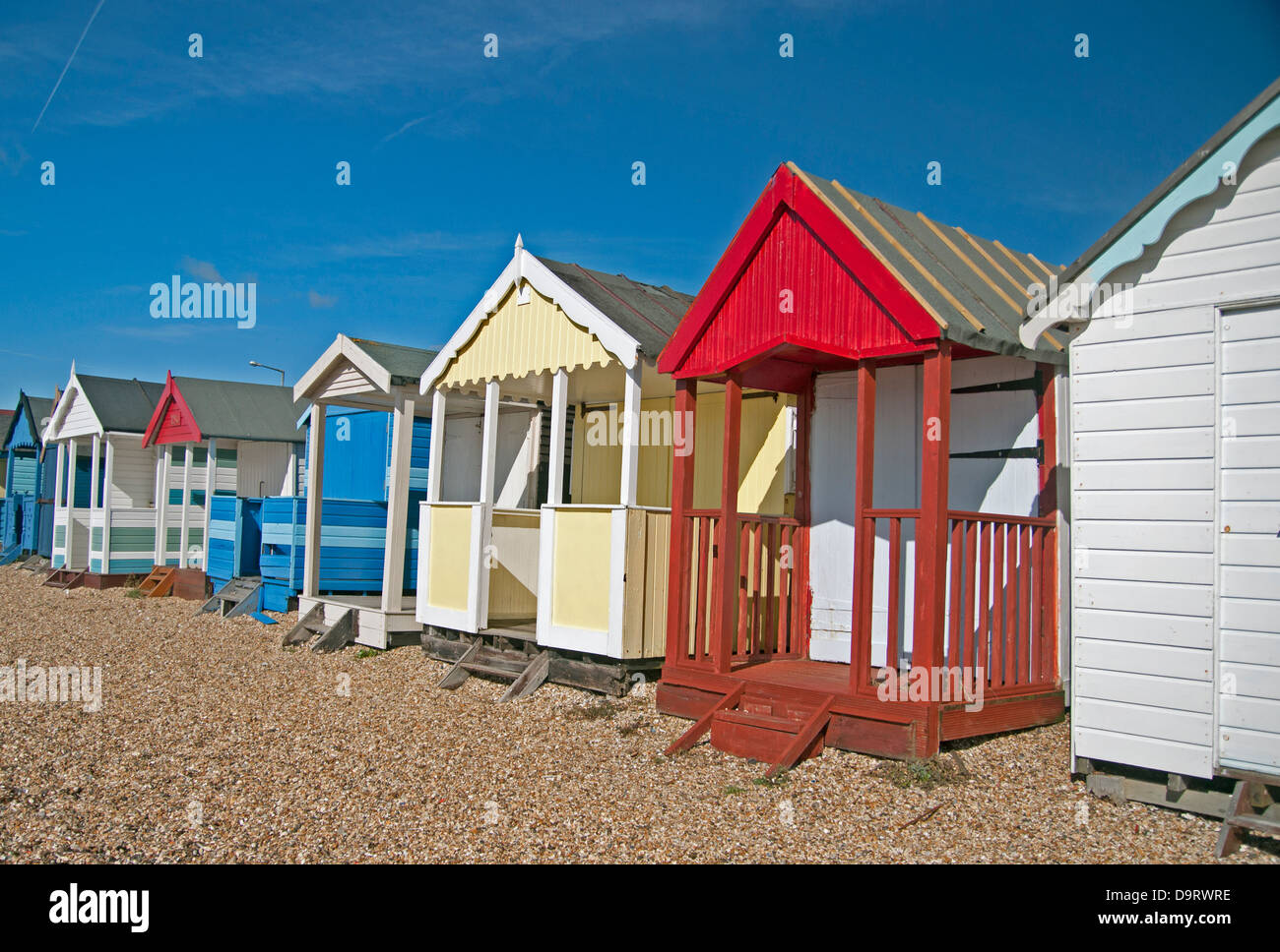 Seafront views showing beach huts , sand, sea and blue sky Stock Photo ...