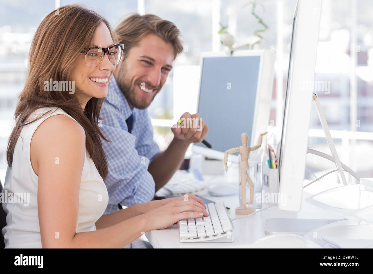 Design team working on computer Stock Photo - Alamy