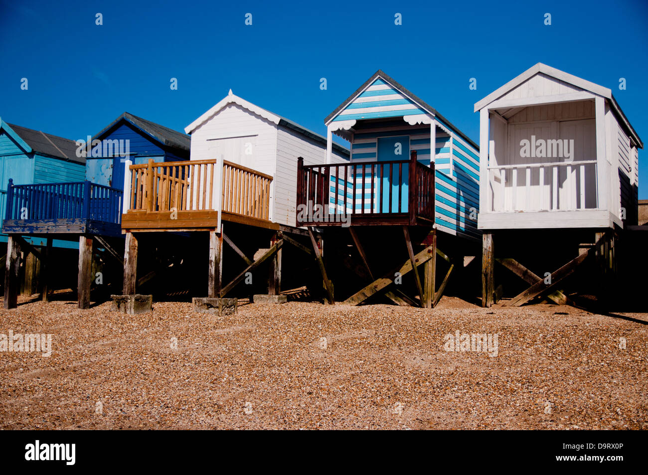 Seafront views showing beach huts , sand, sea and blue sky Stock Photo ...