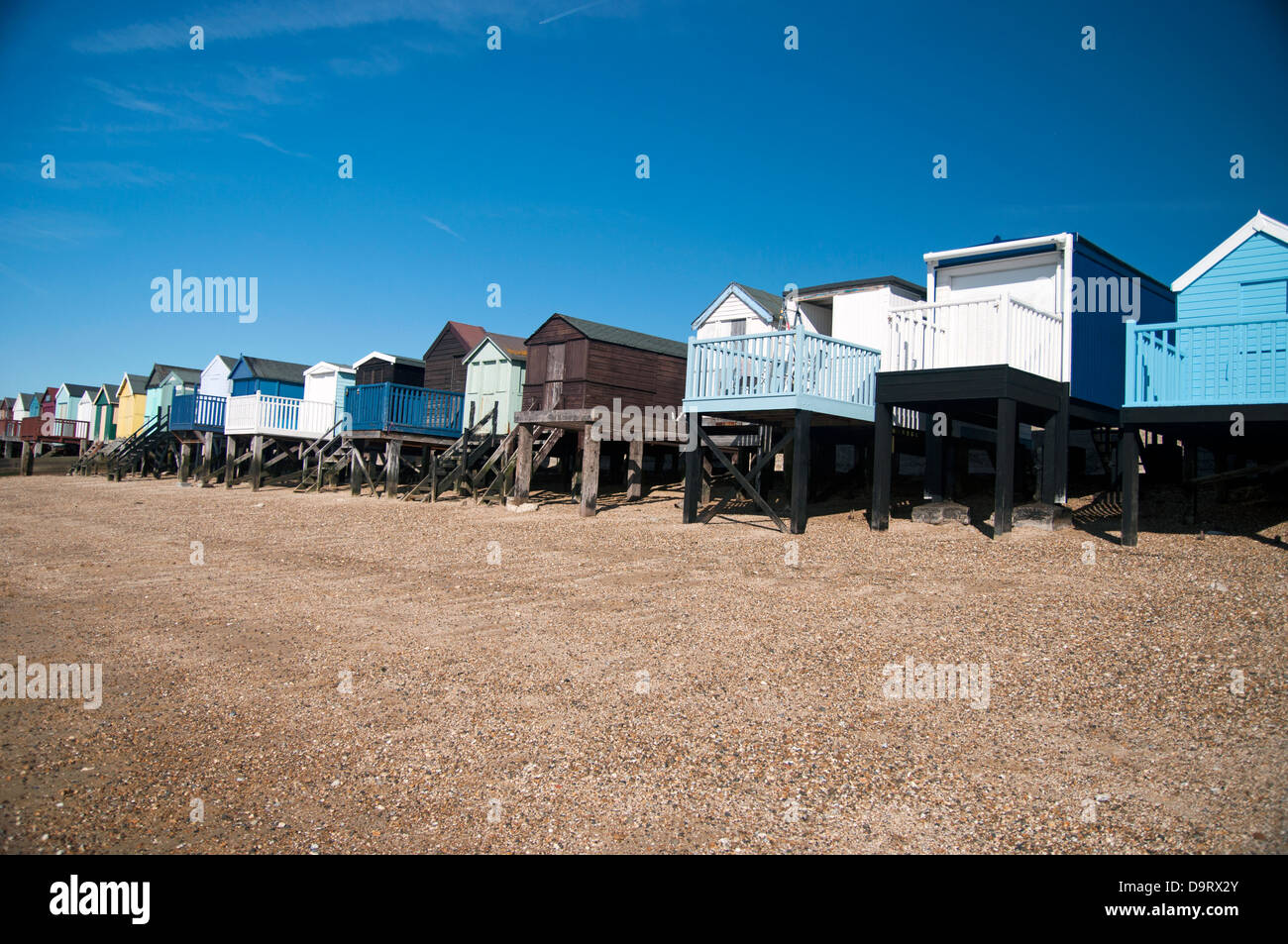 Seafront views showing beach huts , sand, sea and blue sky Stock Photo ...