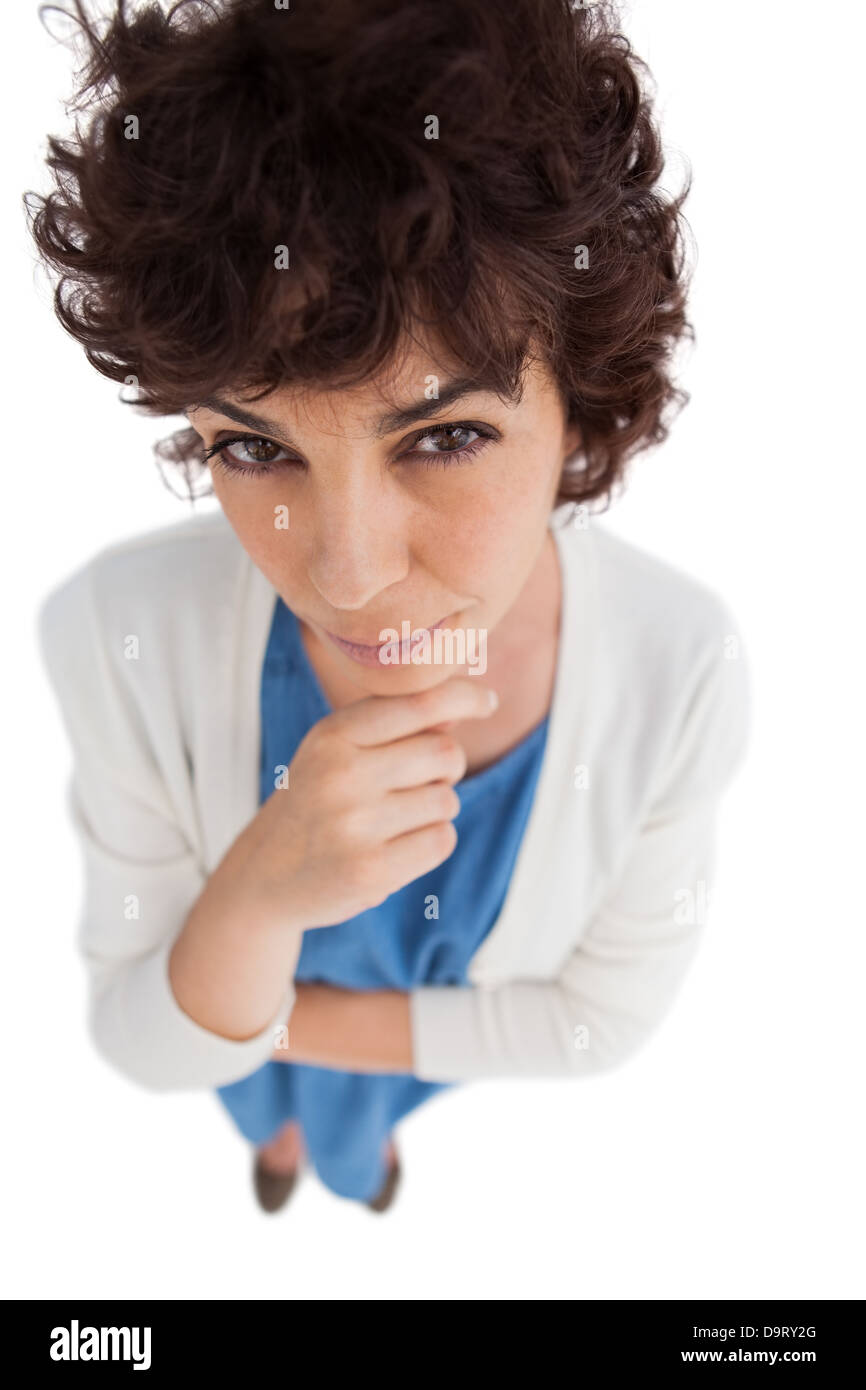 Overhead of thoughtful woman with hand touching her chin Stock Photo ...