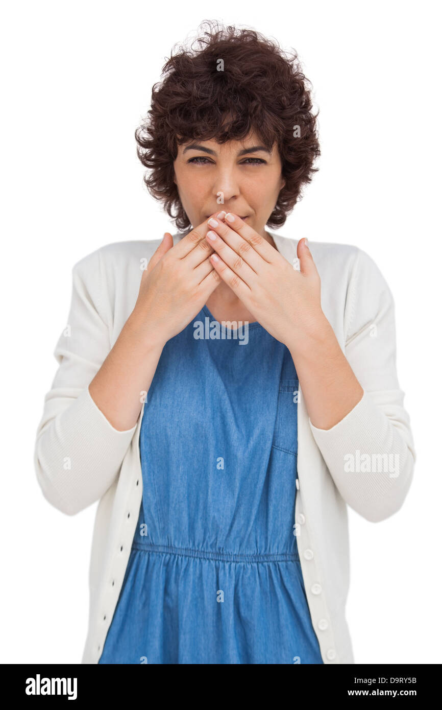 Astonished brunette woman putting hands on mouth Stock Photo - Alamy