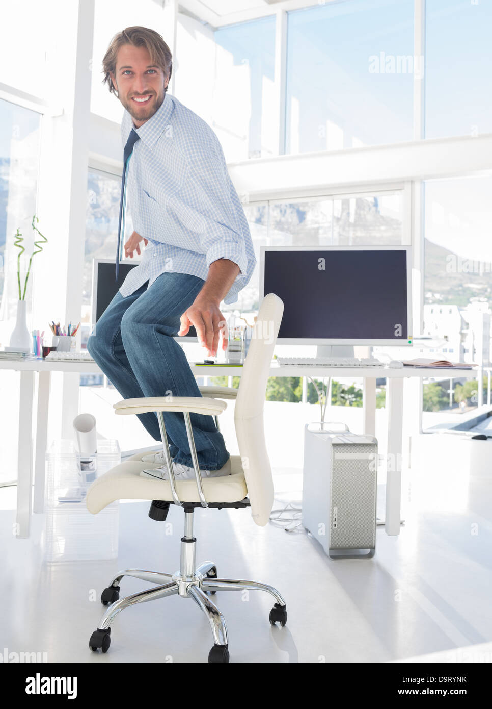 Man surfing his swivel chair Stock Photo - Alamy