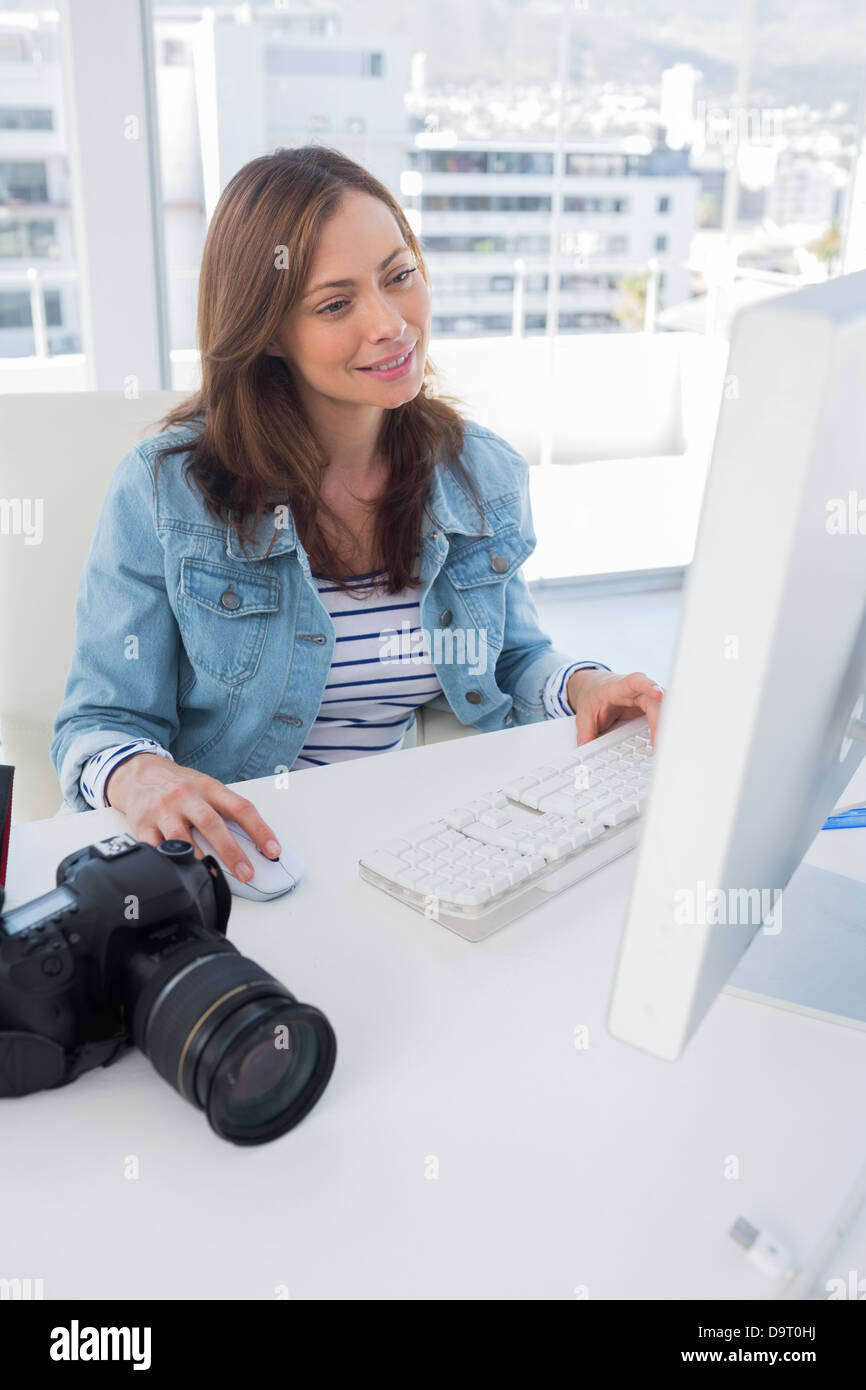 Concentrated photo editor working on computer Stock Photo - Alamy