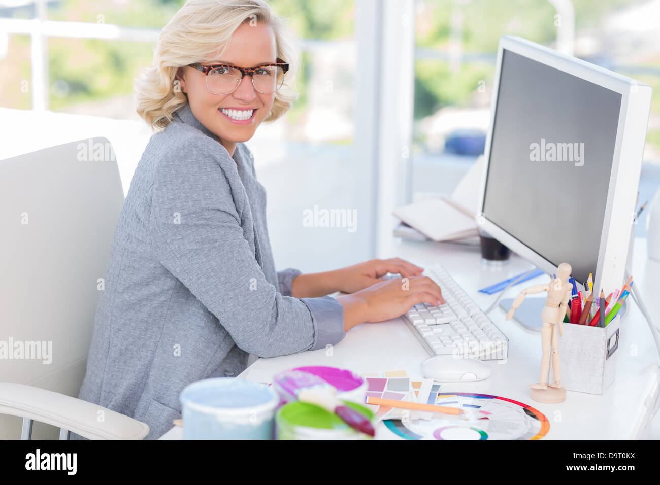 Cheerful interior designer working on her computer Stock Photo - Alamy