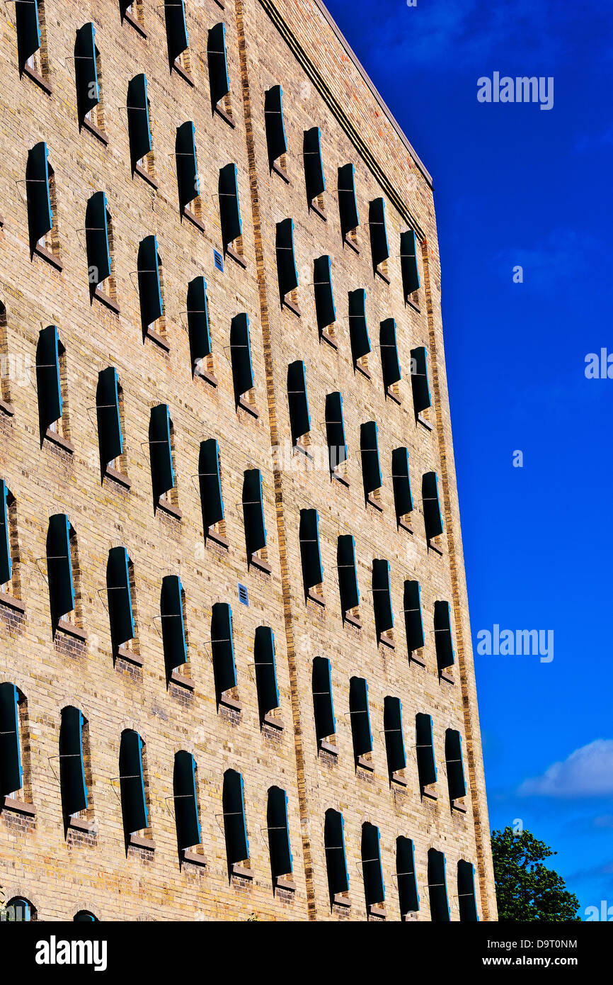Brick building with rows of small shutter windows Stock Photo - Alamy