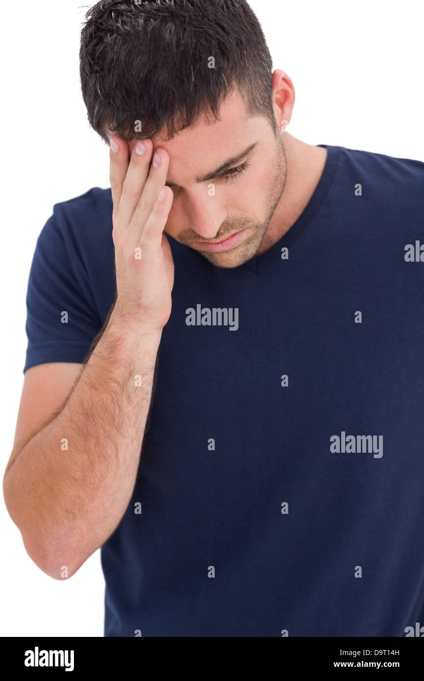Sad man holding his forehead with his hand Stock Photo - Alamy