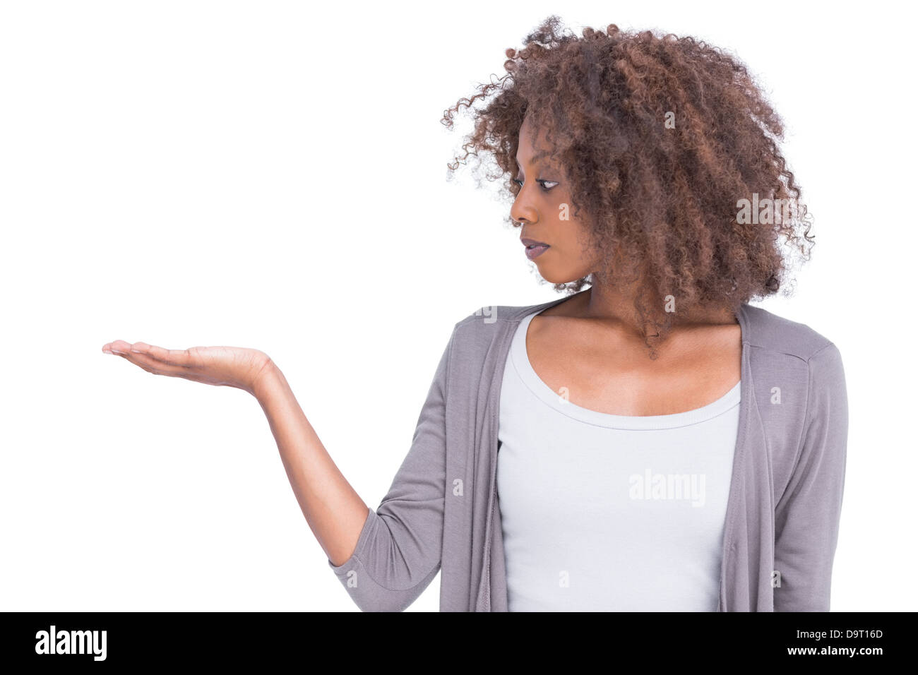 Pretty brunette holding hand out as a presentation Stock Photo - Alamy