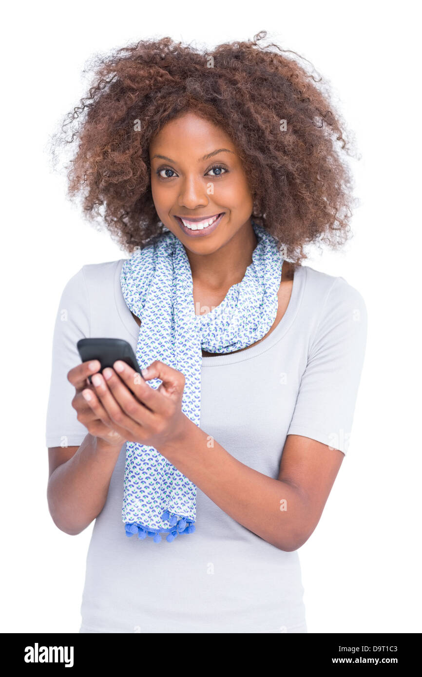 Smiling woman looking at camera and typing a text message Stock Photo ...
