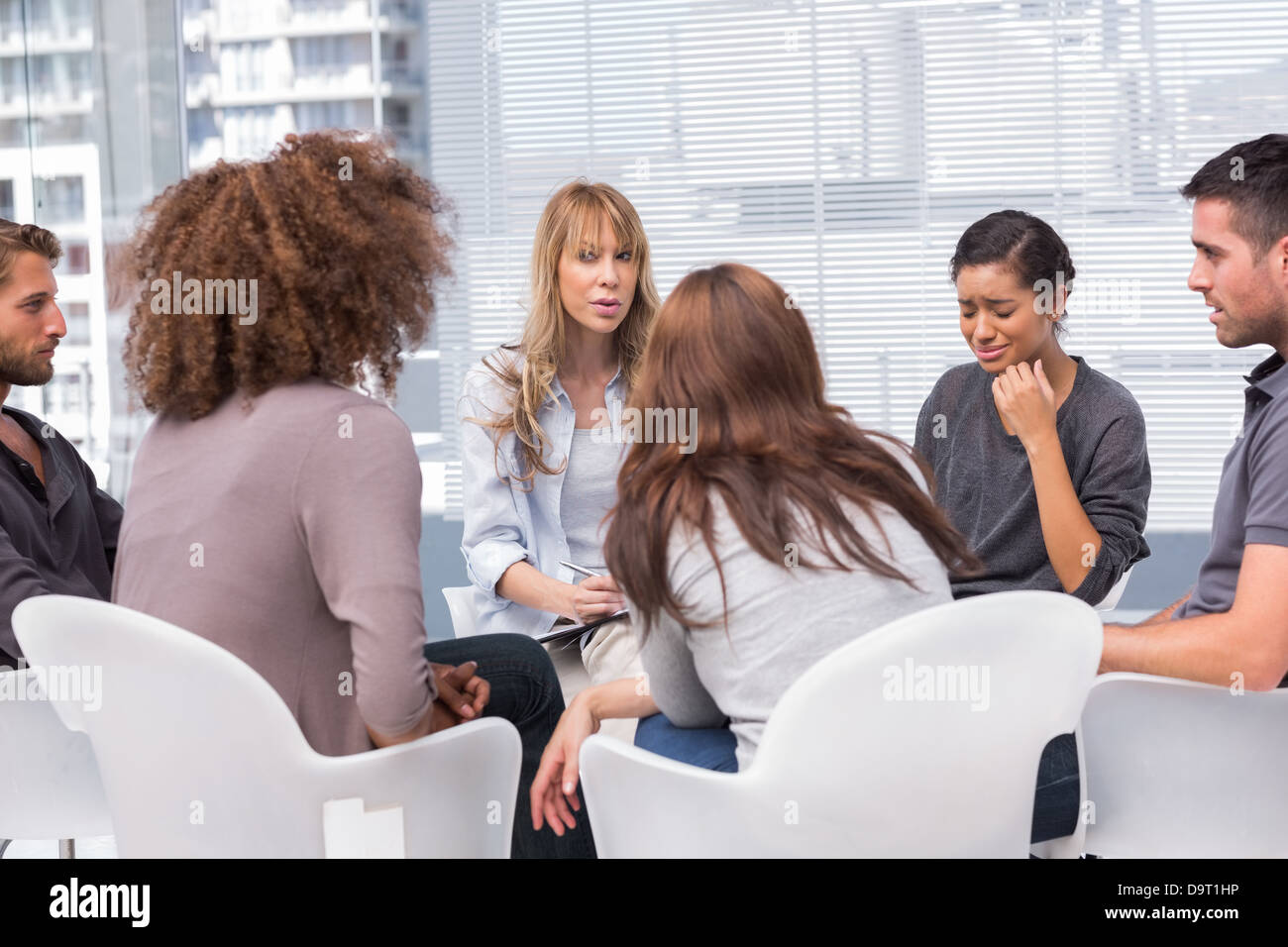 Woman crying during group therapy session Stock Photo - Alamy