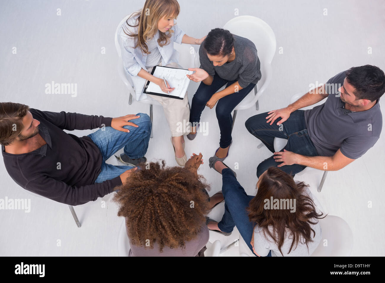 Counselor helping upset female sitting hi-res stock photography and ...