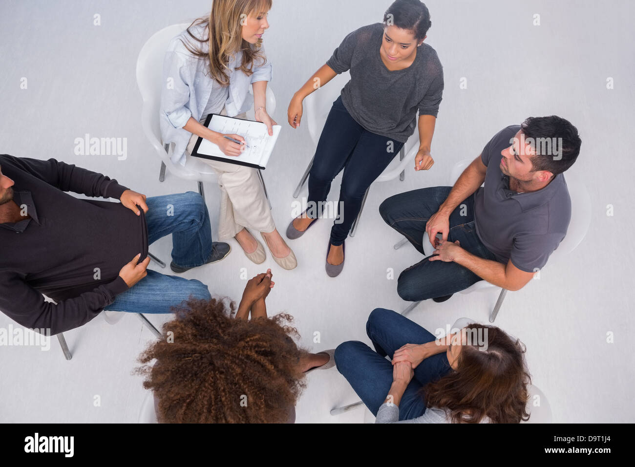 Patients listening to each other in group session Stock Photo - Alamy